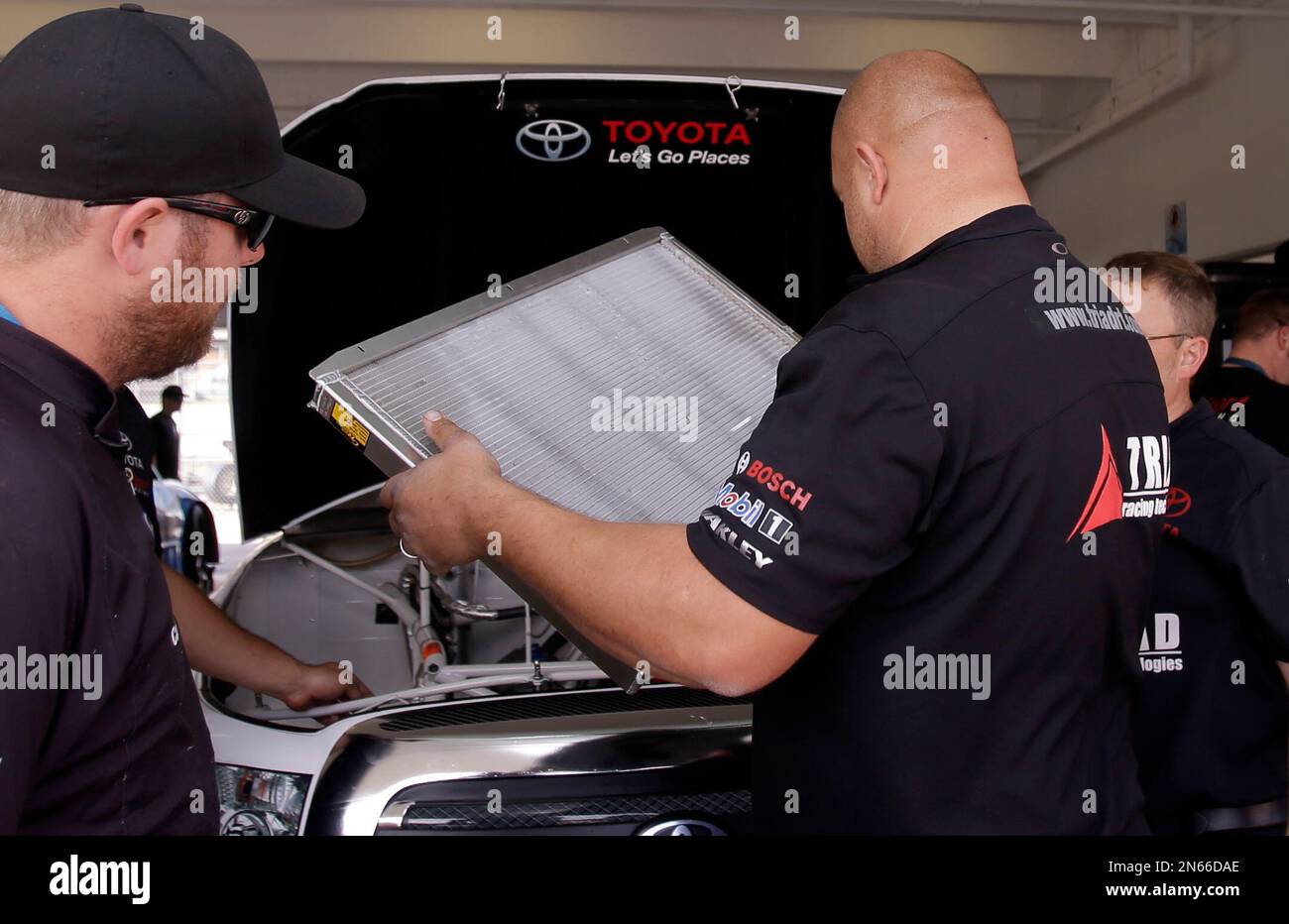 NASCAR Trucks driver Johnny Sauter's crew member Ryan Fike, right, of ...