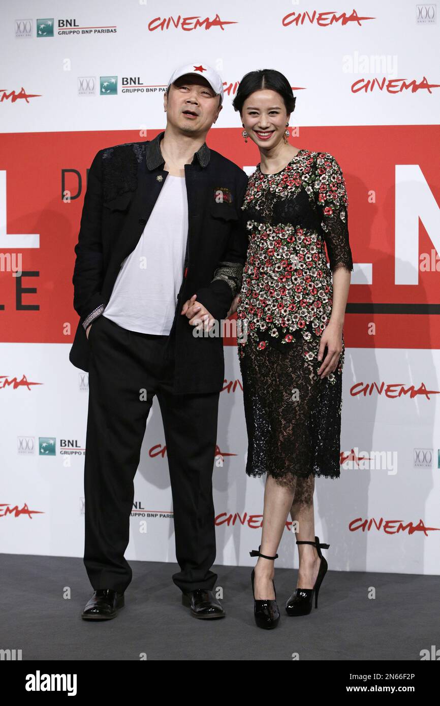 Director Cui Jian, left, and actress Ni Hongjie pose for photographers ...