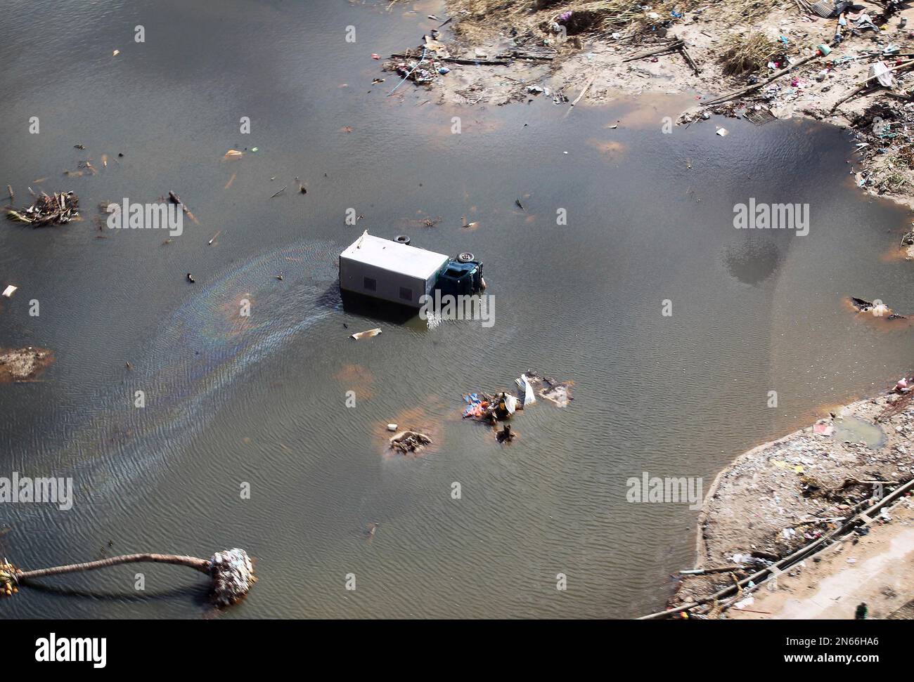 A truck is left stranded in water after it was hit by Typhoon Haiyan ...