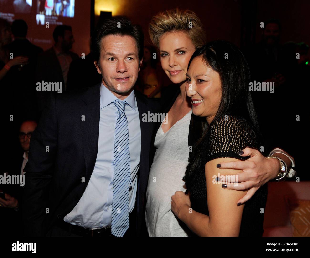 Mark Wahlberg, left, a cast member in "Lone Survivor," poses with ...