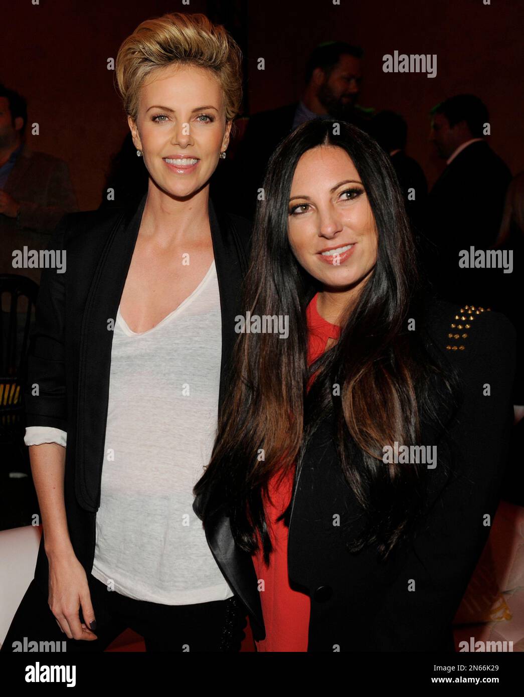 Actress Charlize Theron, left, poses with Melanie Luttrell, wife of ...