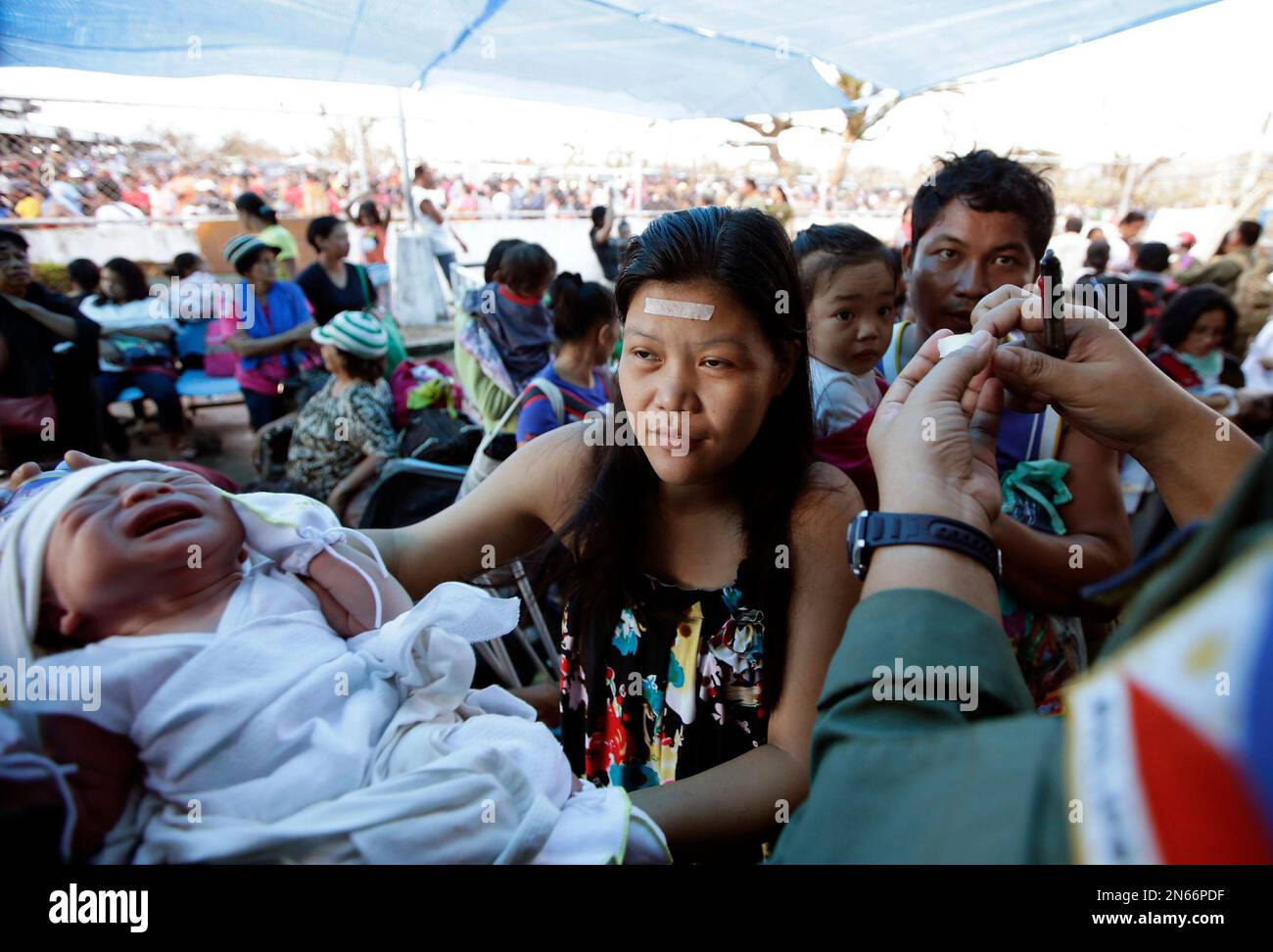 One-day-old baby Ian Daniel Honrado is entrusted by his mother Roselle ...