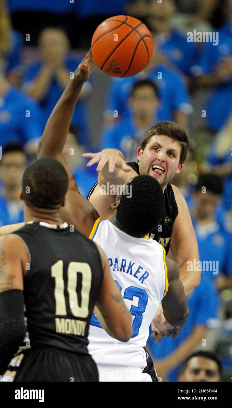 Oakland center Corey Petros, top, blocks a shot by UCLA center Tony ...