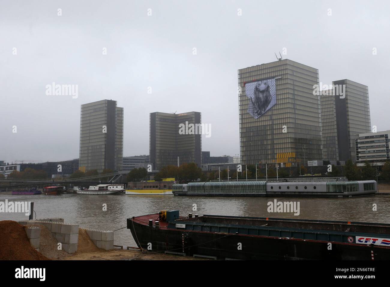 A giant up side down portrait made of paper strips covers the facade of ...