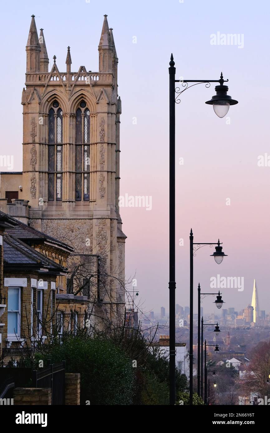 London, UK. Christ Church in Gipsy Hill next to streetlamps, with the ...