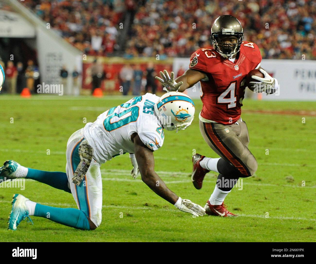 Tampa Bay Buccaneers running back Bobby Rainey, right, slips past Miami ...