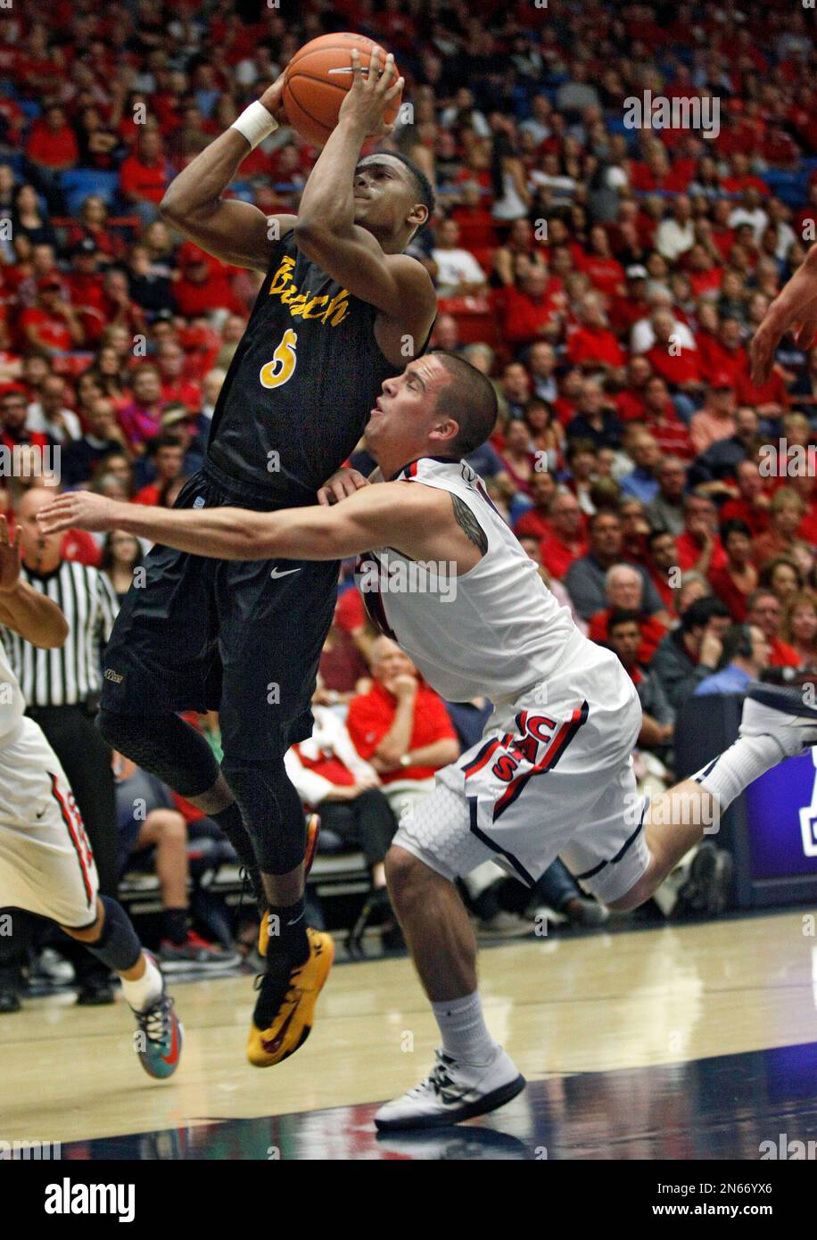 Long Beach State's Mike Caffey (5) shoots over Arizona's T.J. McConnell ...