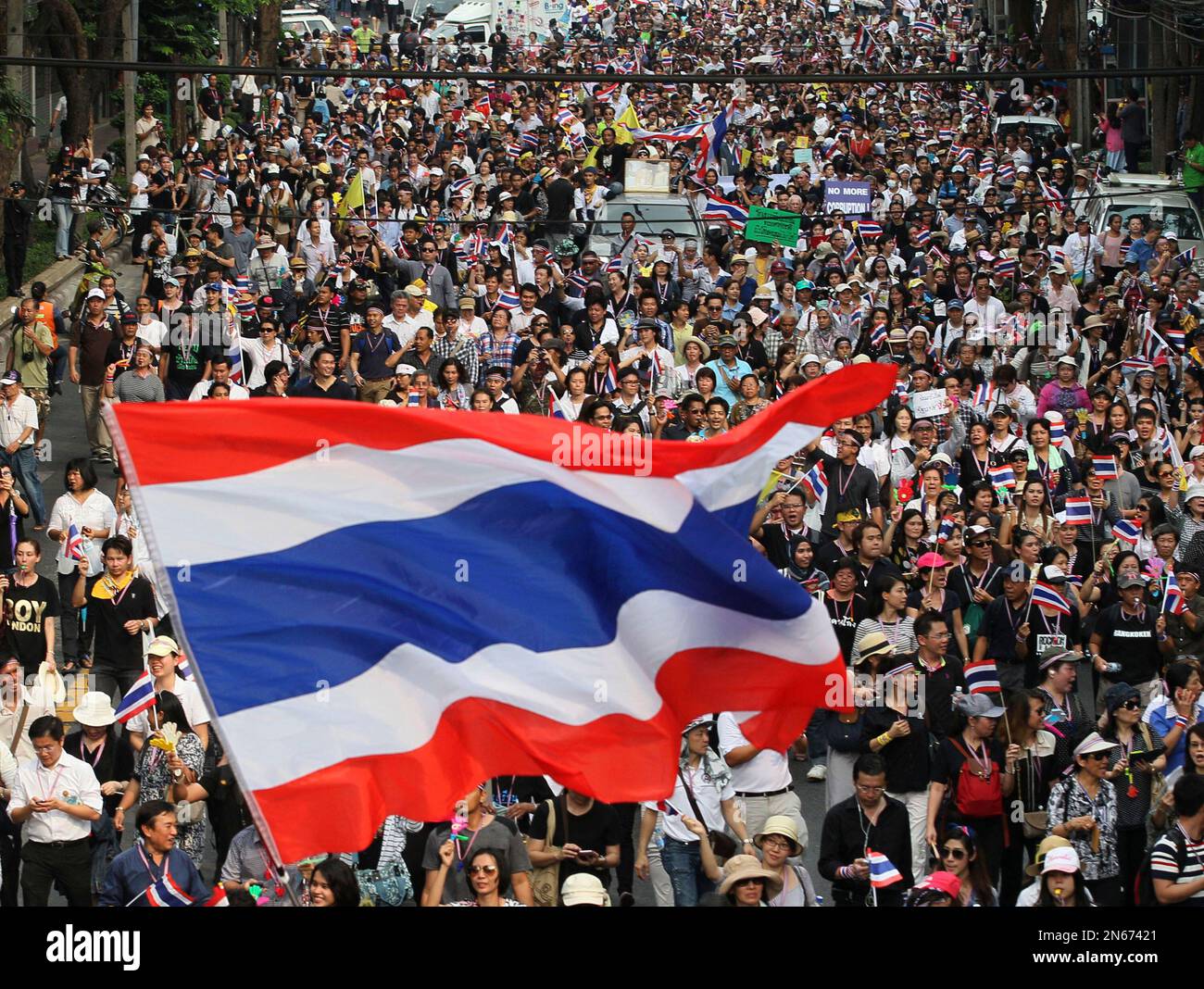 Anti-government demonstrators wave their national flags while chanting ...