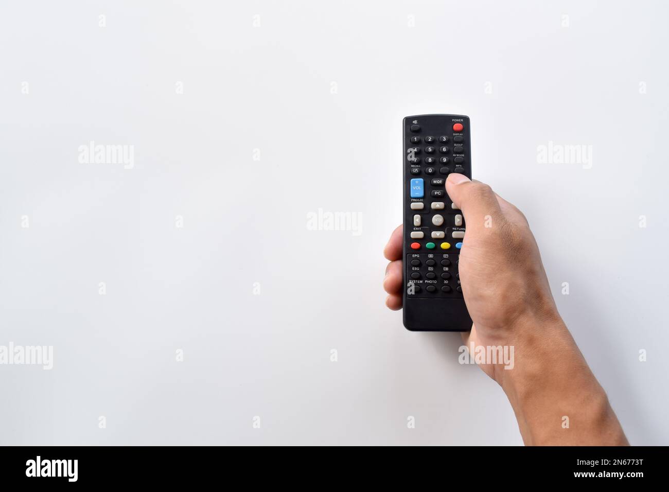 Hand holding television remote control isolated on white background ...