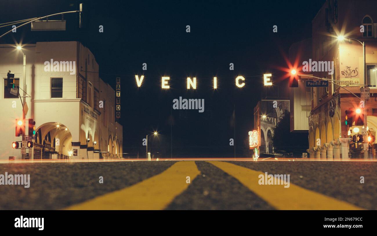 Venice Beach Sign illuminates the street on a quiet evening with nobody ...