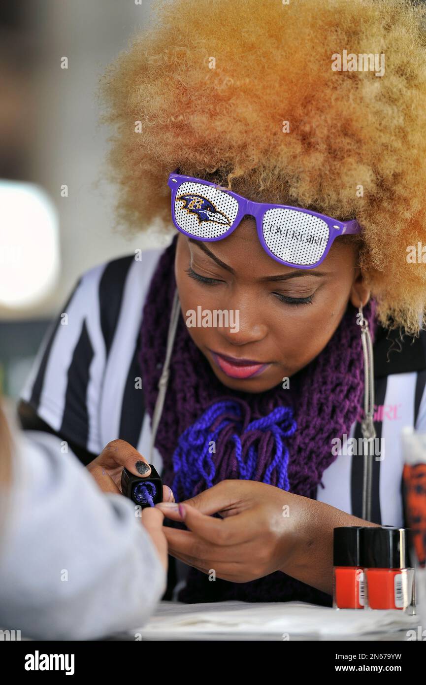 Kim Wiggins applies nail polish for a football fan during Cover Girls ...