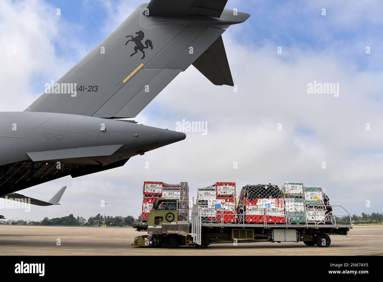 Pallets containing various aid supplies are loaded onto a C-17A ...