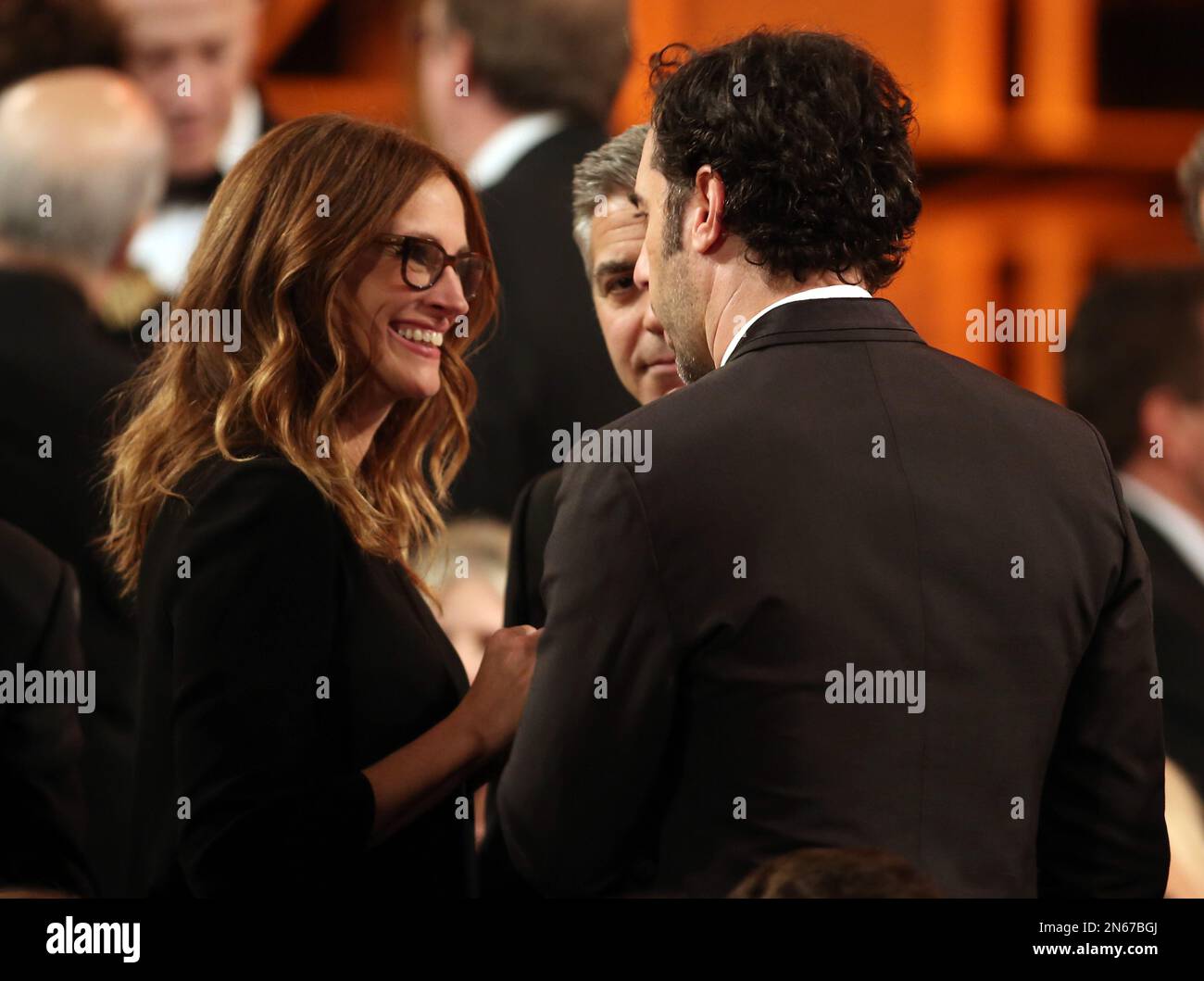 Julia Roberts, left, George Clooney, center, and Sacha Baron Cohen ...