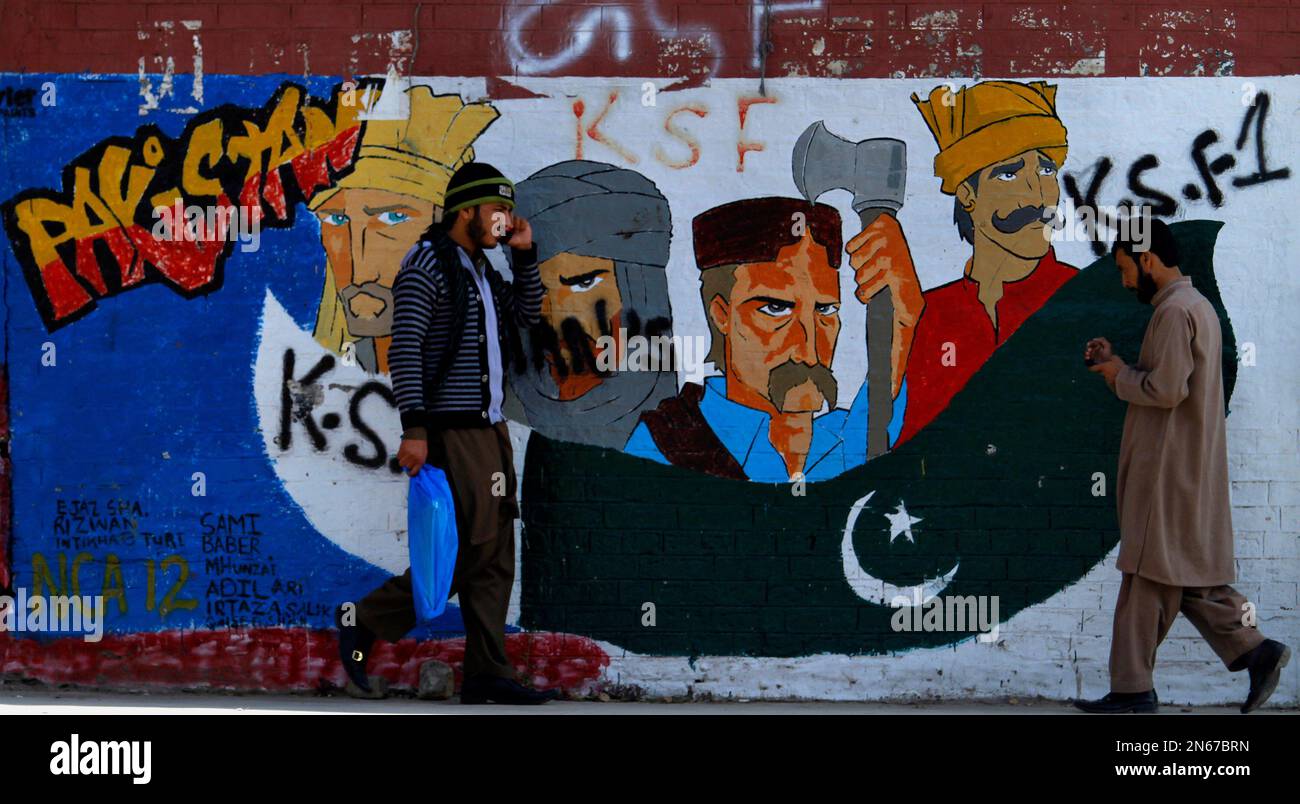 Pakistanis walk past a mural on the boundary wall of a collage in ...