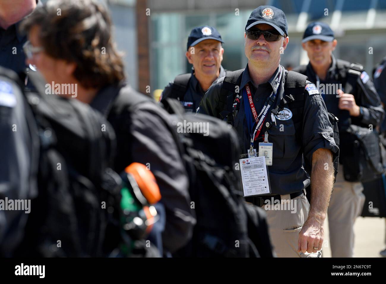 Fire and Rescue NSW personnel, along with Australia Assists personnel ...