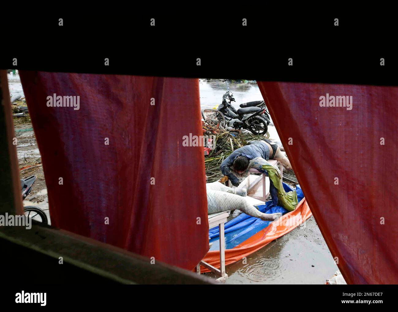 EDS NOTE: GRAPHIC CONTENT - Bodies of typhoon victims are placed along ...