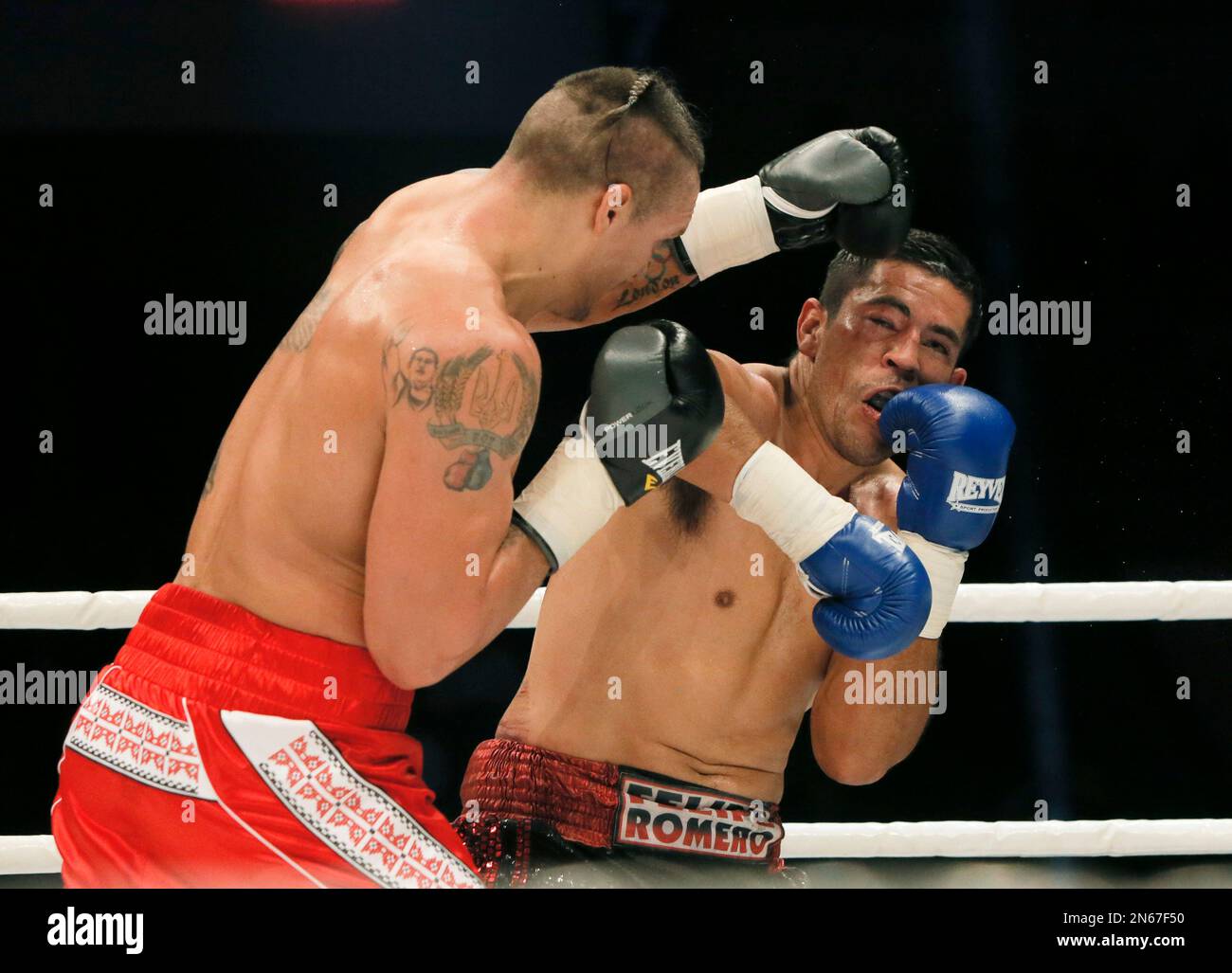 Ukrainian boxing Olympic champion Oleksandr Usyk, left, throws a punch ...