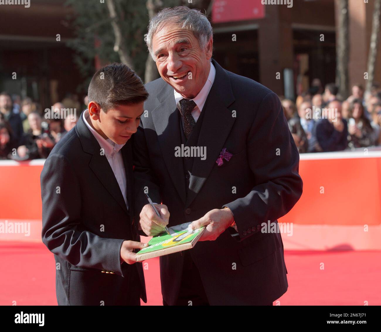 Composer Rocco Granata, right signs autographs with young actor ...