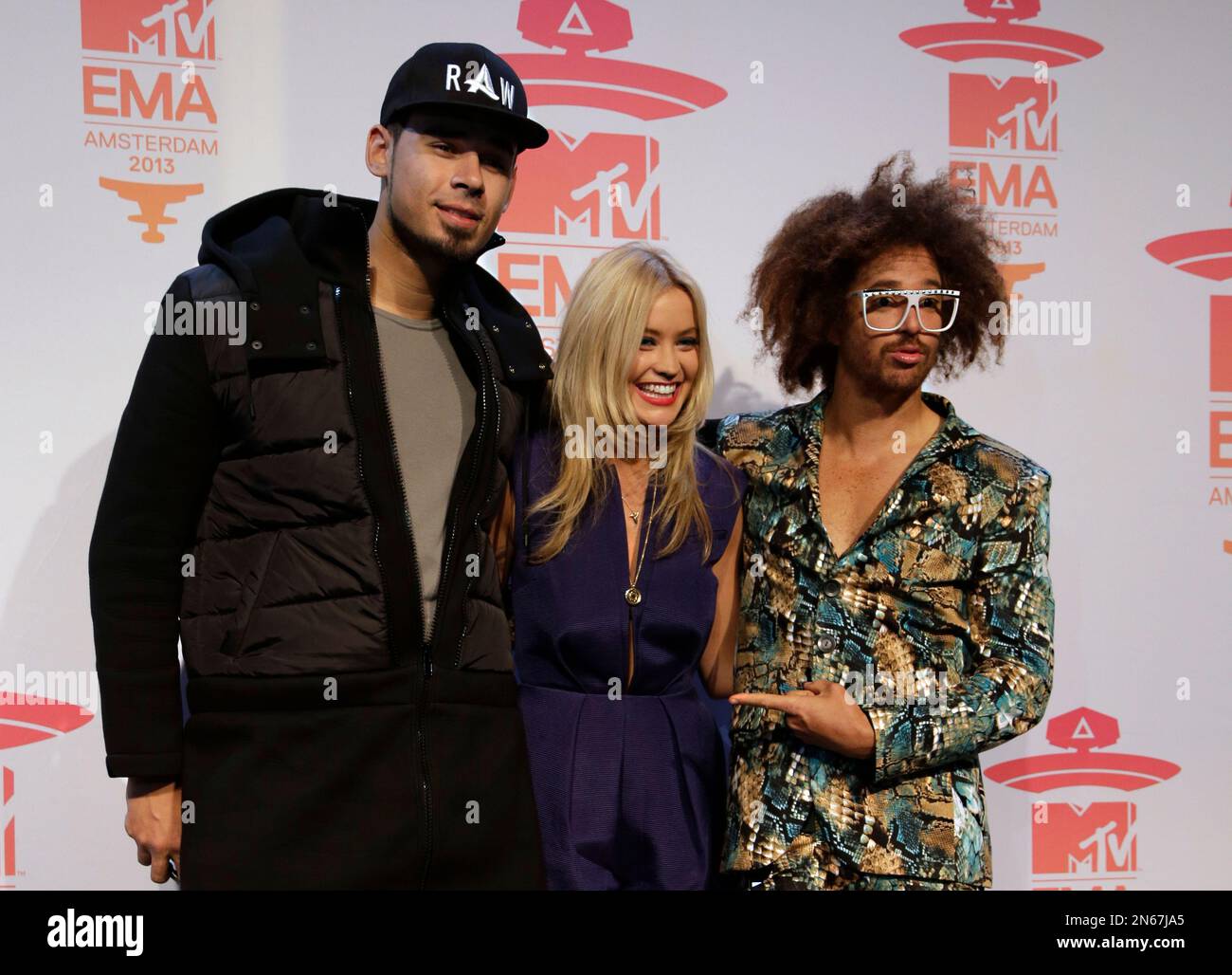DJ Afrojack, presenter Laura Whitmore and musician Redfoo pose for ...