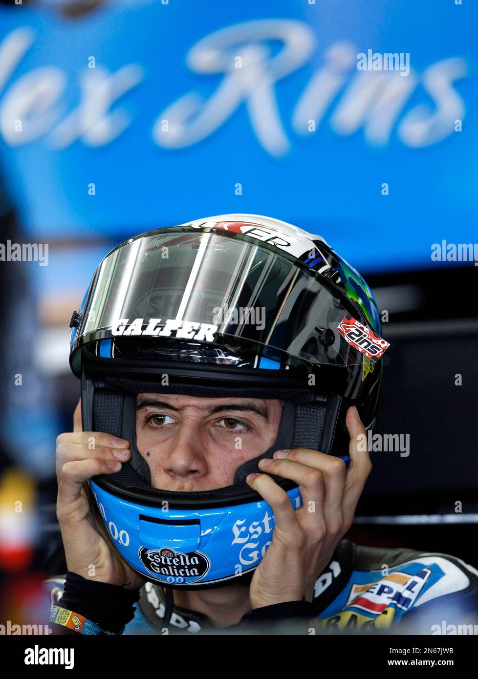 Moto3 KTM rider Alex Rins from Spain puts on his helmet in the team box ...