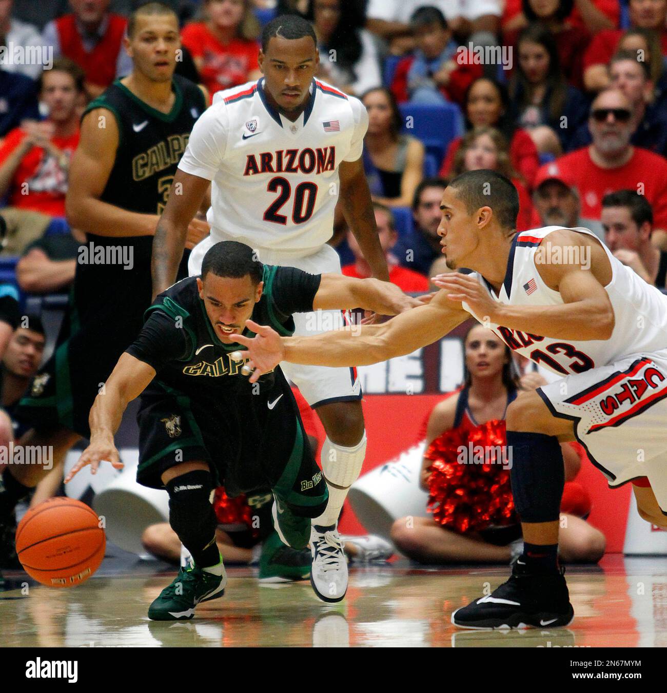 Cal Poly's Jamel Johnson, left, and Arizona's Nick Johnson scramble for ...