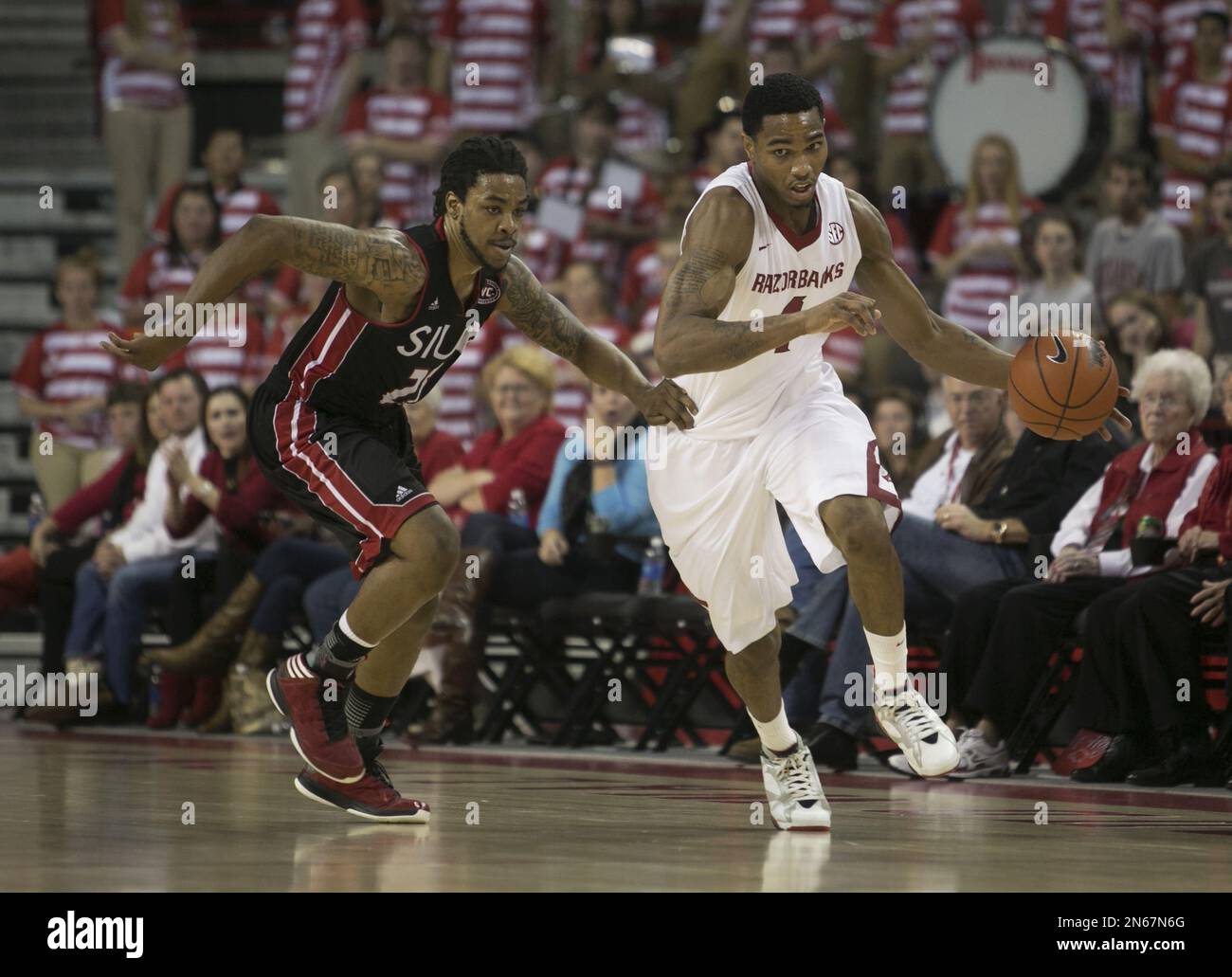 SIU-Edwardsville forward Keaton Scheer, left, defends against Arkansas ...