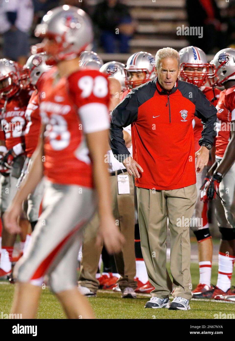 New Mexico head coach Bob Davie, right, watches his kicker Justus Adams ...