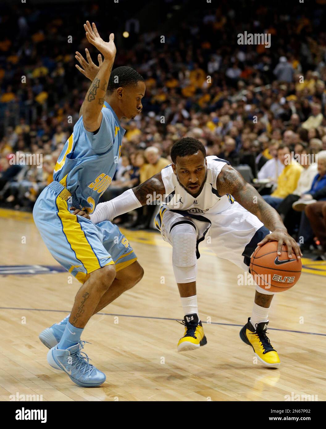 Marquette's Todd Mayo tries to drive past Southern University's Tre ...