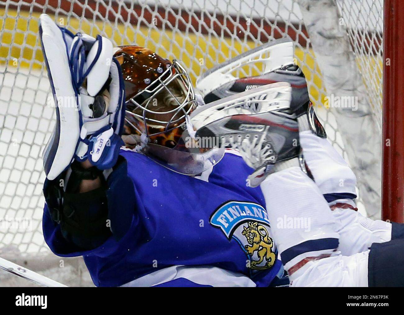 Finland goalie Noora Raty loses her helmet and mask as United States ...