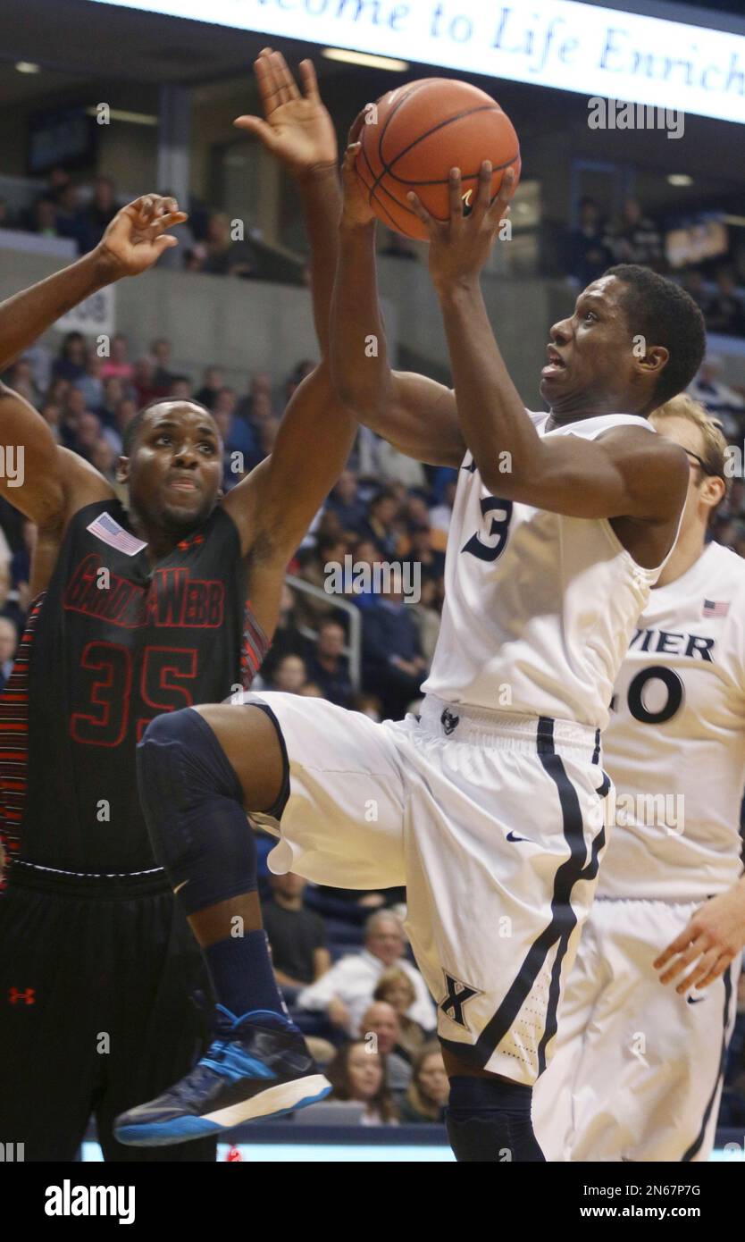 Xavier's James Farr shoots past Gardner-Webb's Jerome Hill, left, in ...