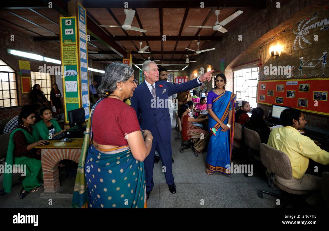 Britain's Prince Charles points towards pictures on a wall during his ...