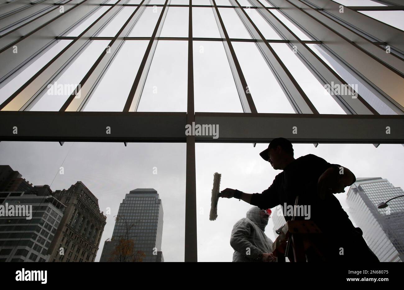Workers clean the glass windows at the lobby of 4 World Trade Center ...