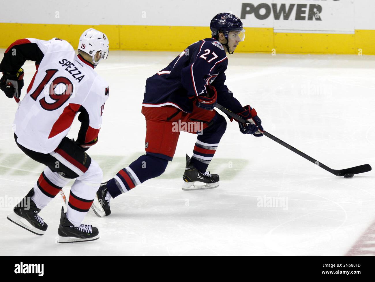 Columbus Blue Jackets' Ryan Murray, right, carries the puck against the ...