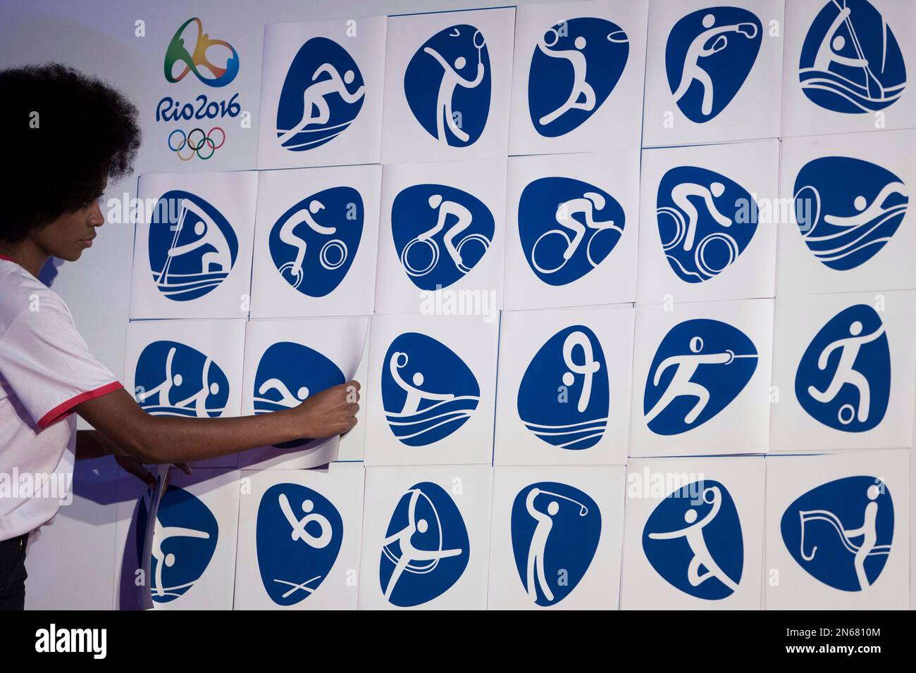 A woman arranges pictograms icons that will be used for the Rio 2016 ...