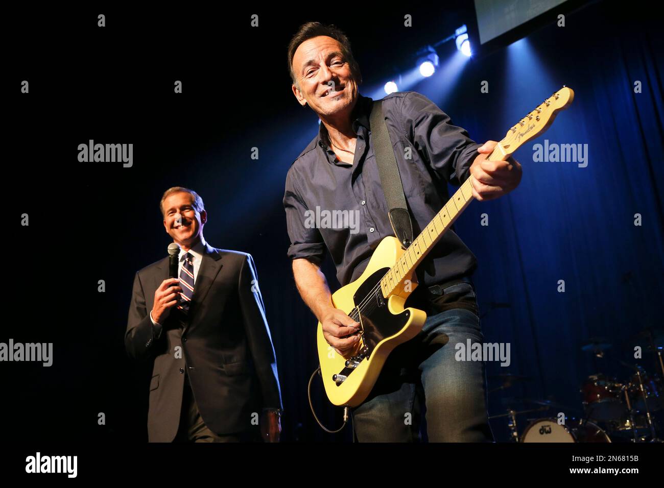 Musician Bruce Springsteen plays a guitar intended for auction ...
