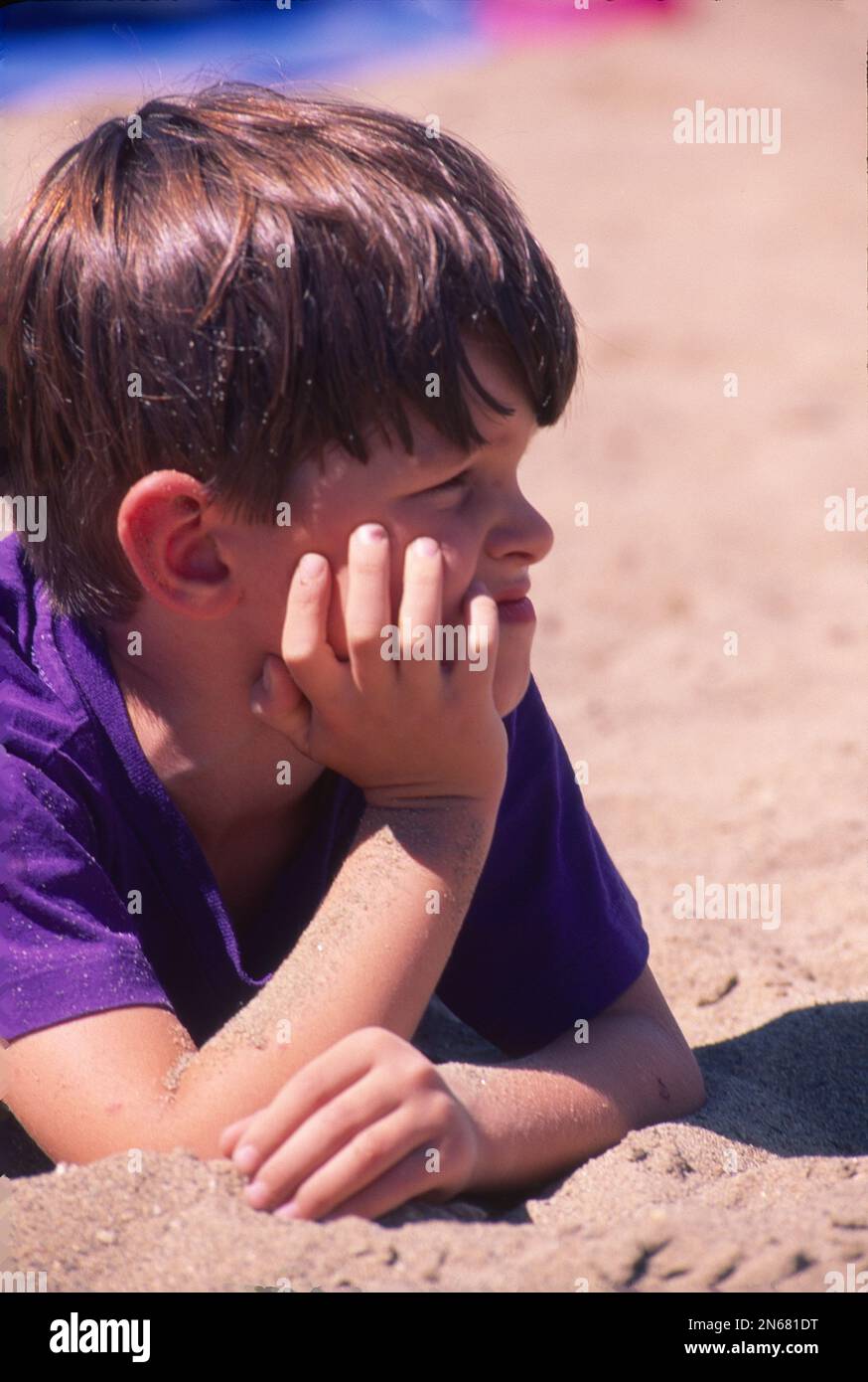 Child laying in sand hi-res stock photography and images - Alamy
