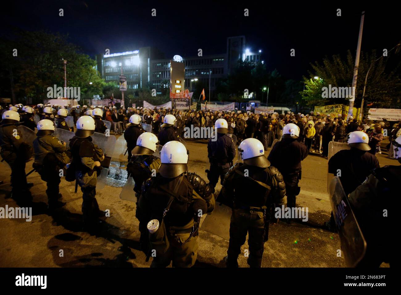 Riot police surrounds workers and supporters outside the main entrance ...