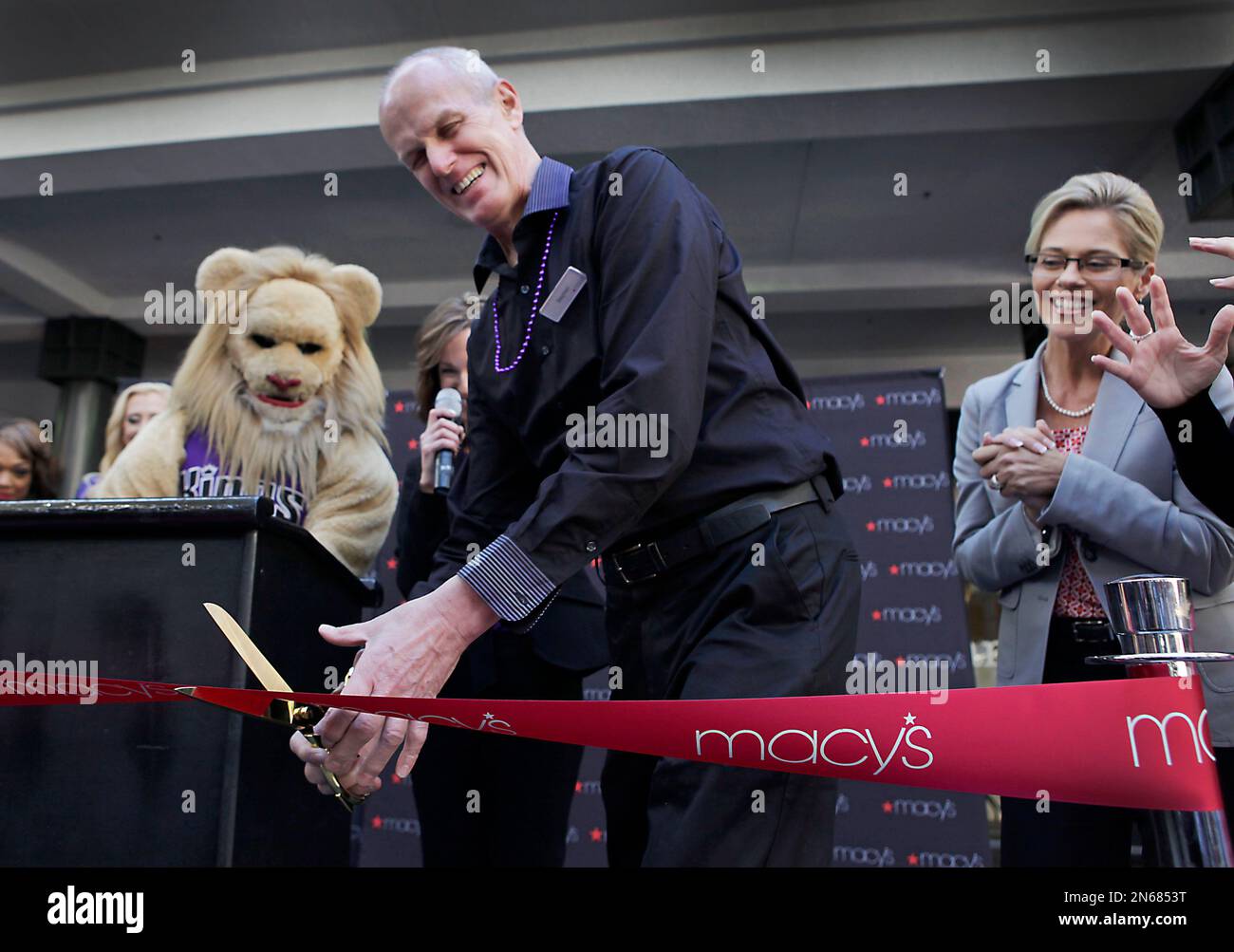 Stephen Muir of Macy's men's department cuts the ribbon as Macy's ...