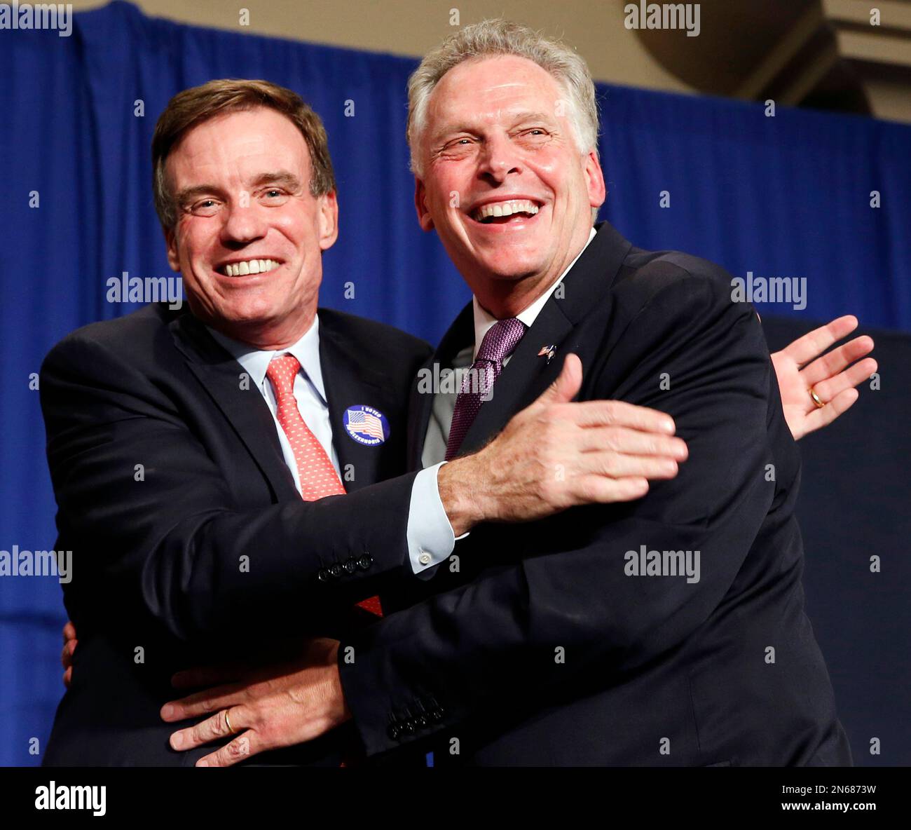 Sen. Mark Warner, D-Va., left, smiles and hugs Virginia Democratic Gov ...