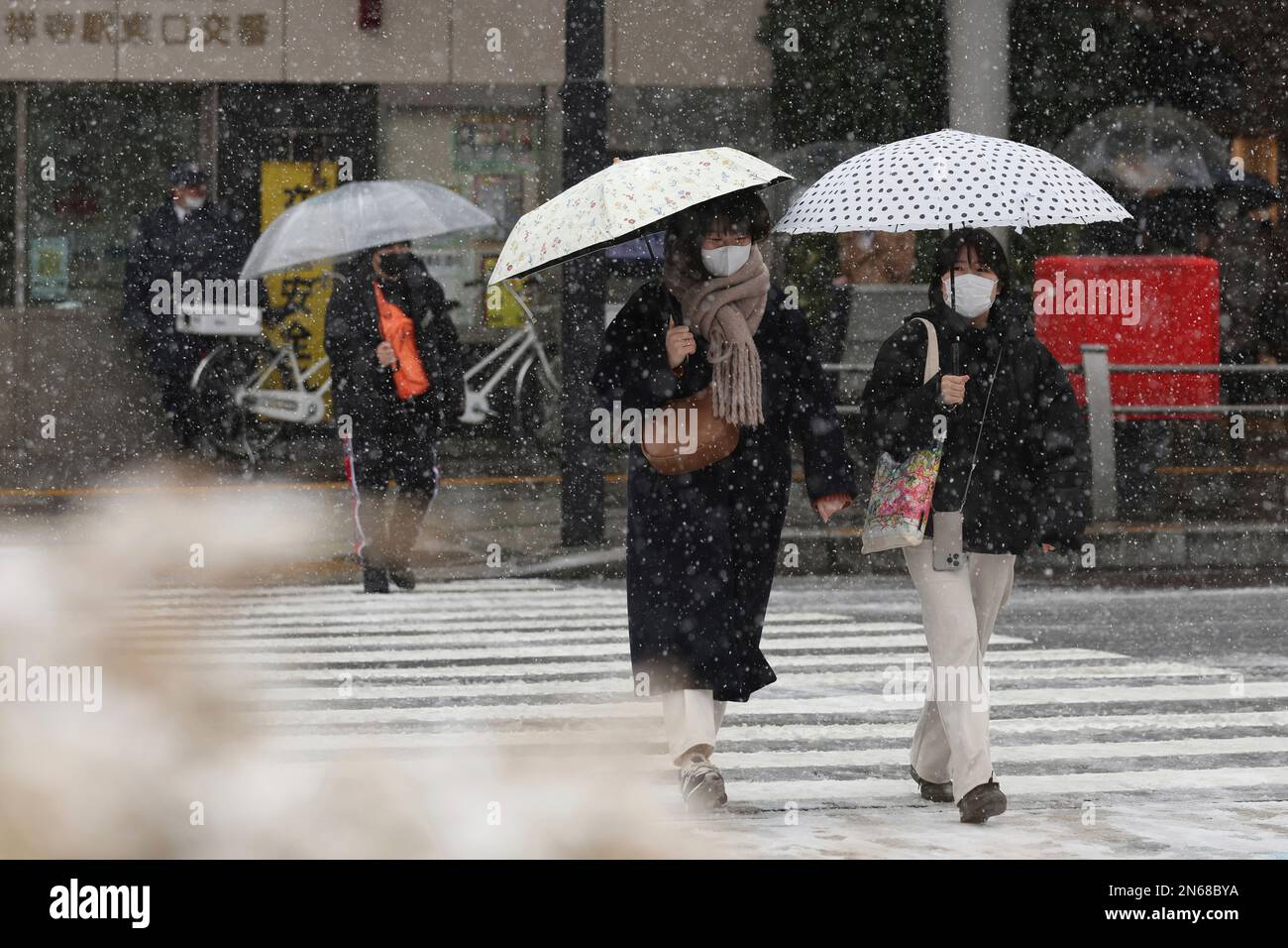 People walk in snow near Kichijoji Station in Musashino City, Tokyo on ...