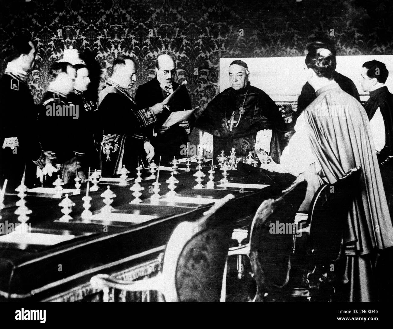 Premier Benito Mussolini is shown reading the Treaty of the Lateran ...