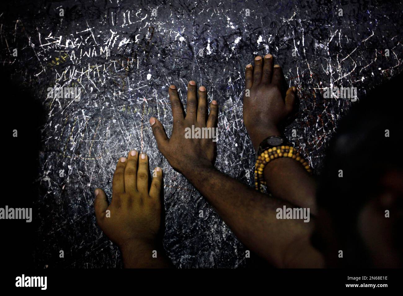 FILE - In this Monday, Oct. 14, 2013 file photo, Muslim pilgrims touch ...