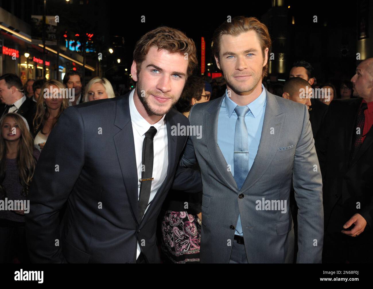 Liam Hemsworth, left, and Chris Hemsworth arrive at the U.S. premiere ...