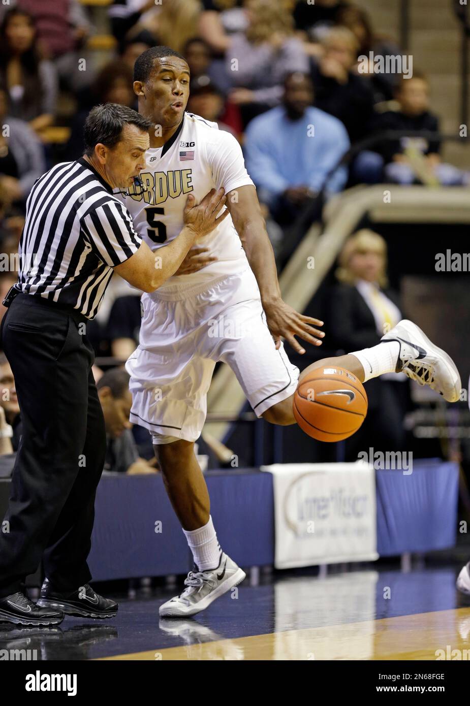 Purdue forward Basil Smotherman, right, crashes into official Todd ...