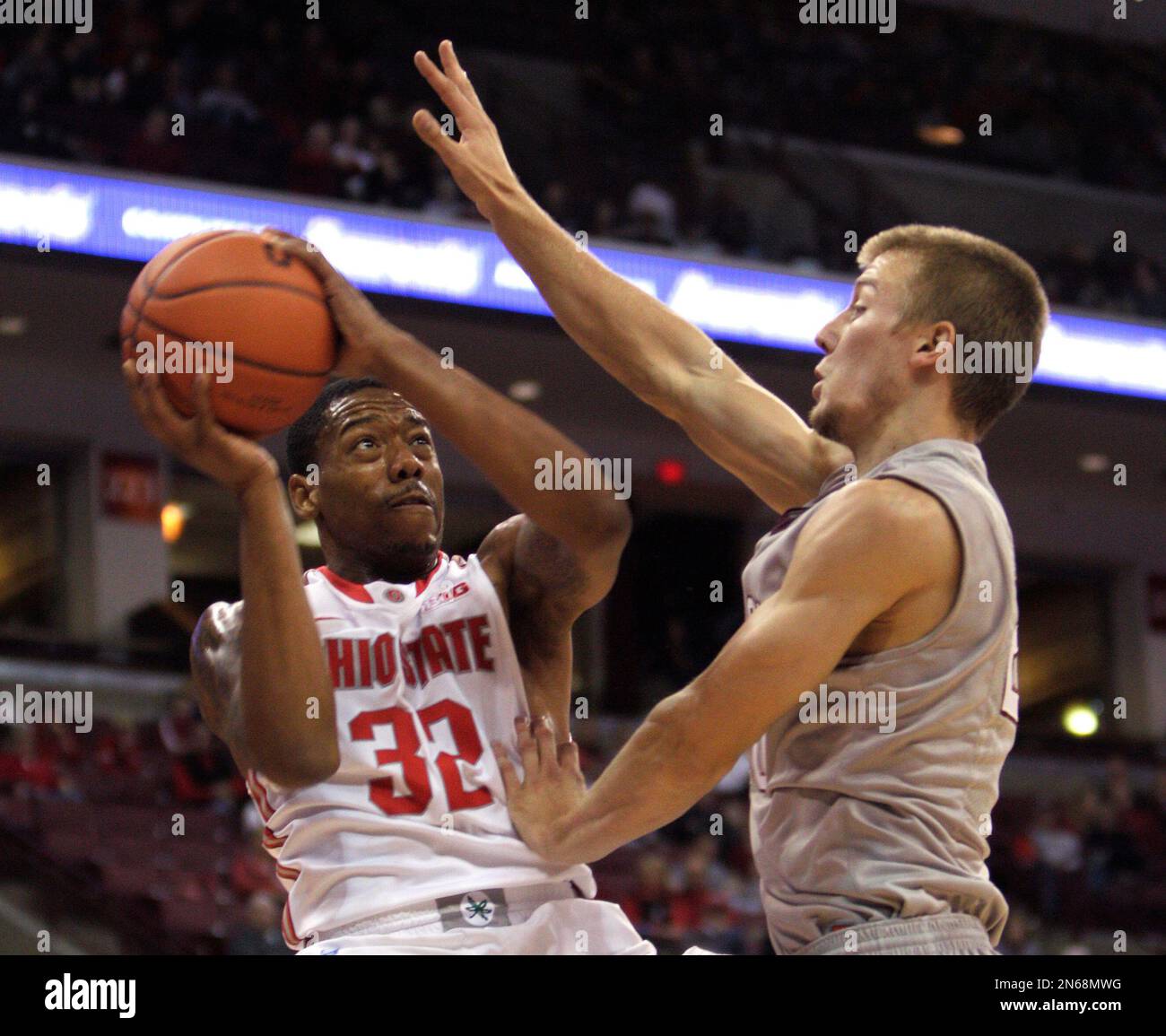 Ohio State's Lenzelle Smith, left, tries to shoot over Walsh's Lucas ...