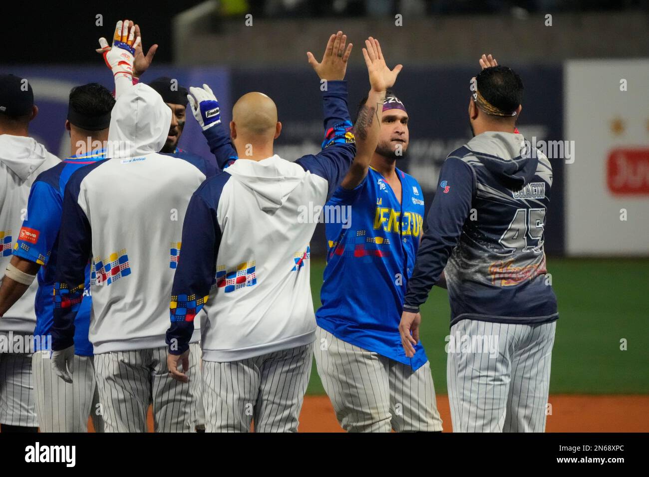 Venezuela's players celebrate after defeating Colombia 7-5 during a ...