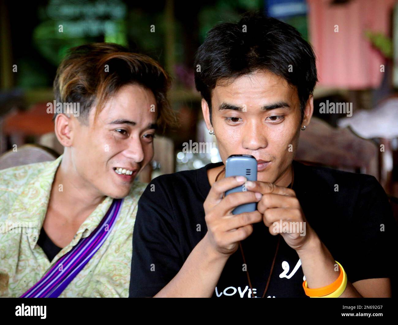 In this Sept. 26, 2013 photo, Johnny, left, watches his twin brother ...