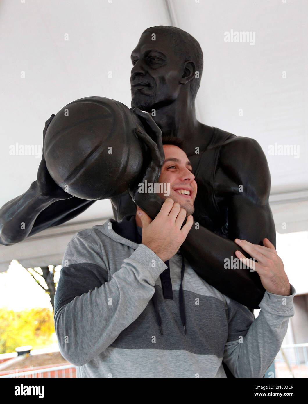John Tangney, of Worcester, Mass., poses with a newly unveiled statue ...