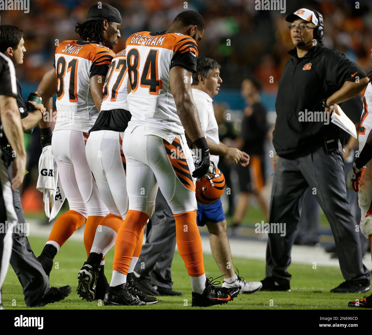 Cincinnati Bengals defensive tackle Geno Atkins (97), center, is helped ...