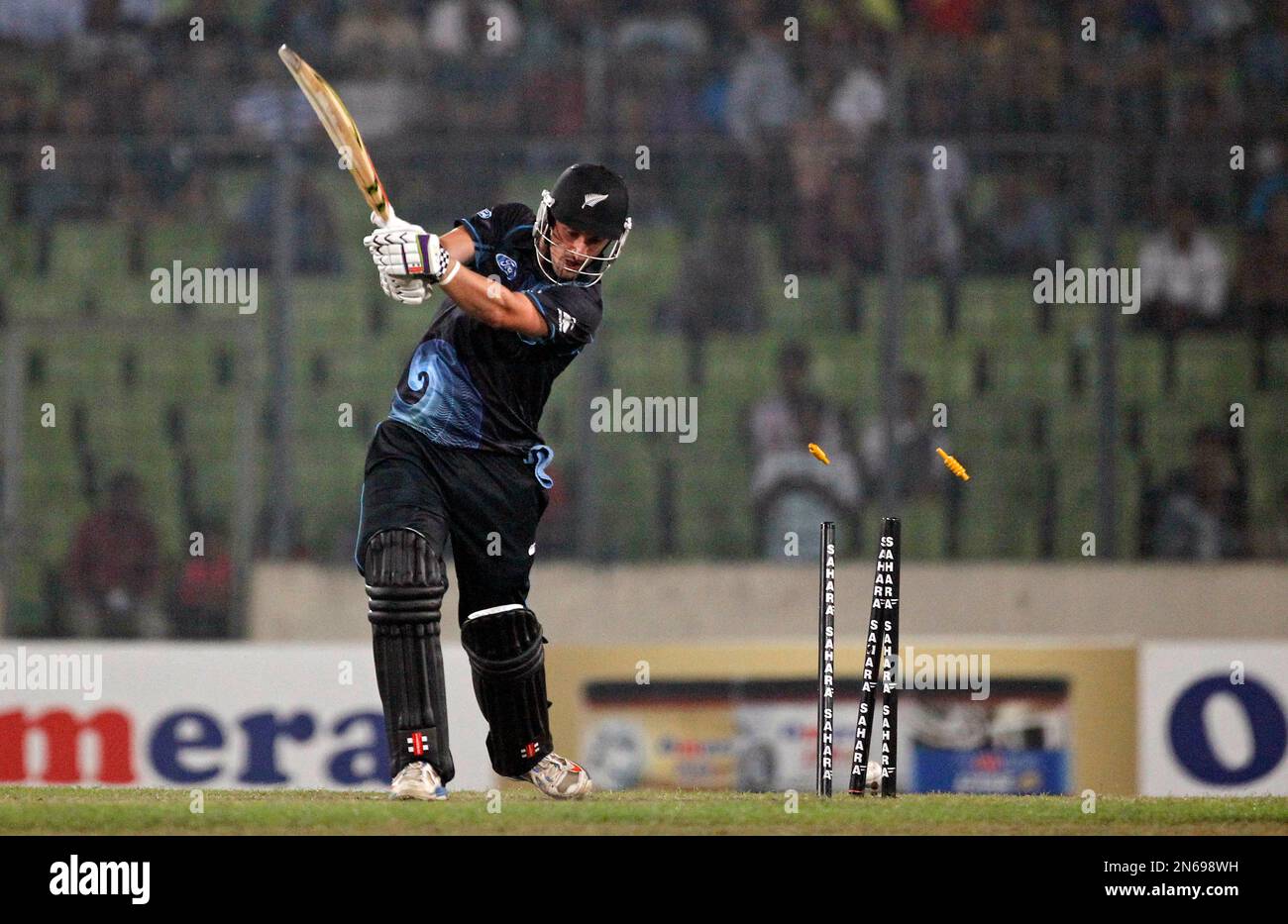 The bails fly off the wicket to dismiss New Zealand’s Hamish Rutherford ...